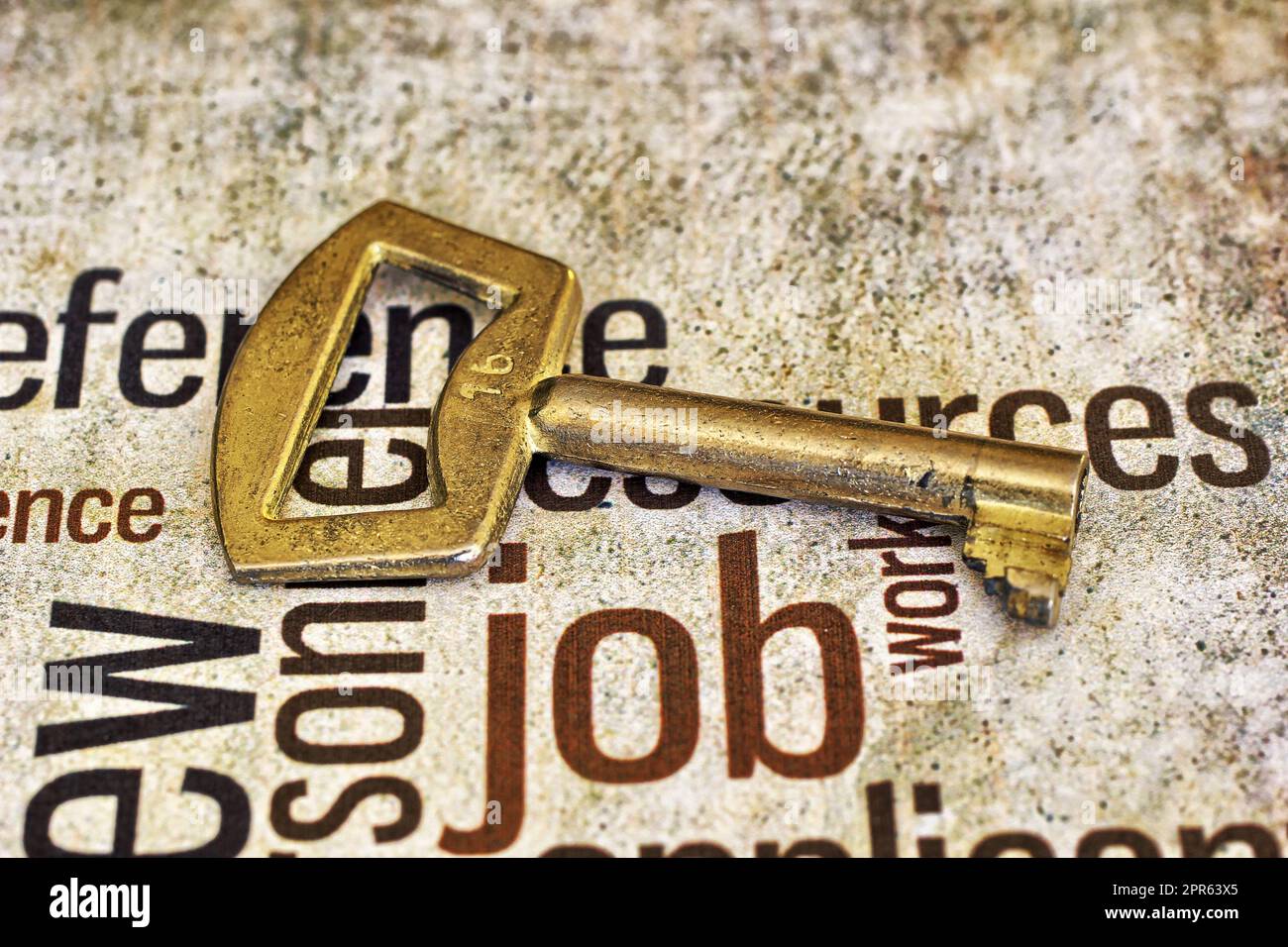 Golden key on job text Stock Photo - Alamy
