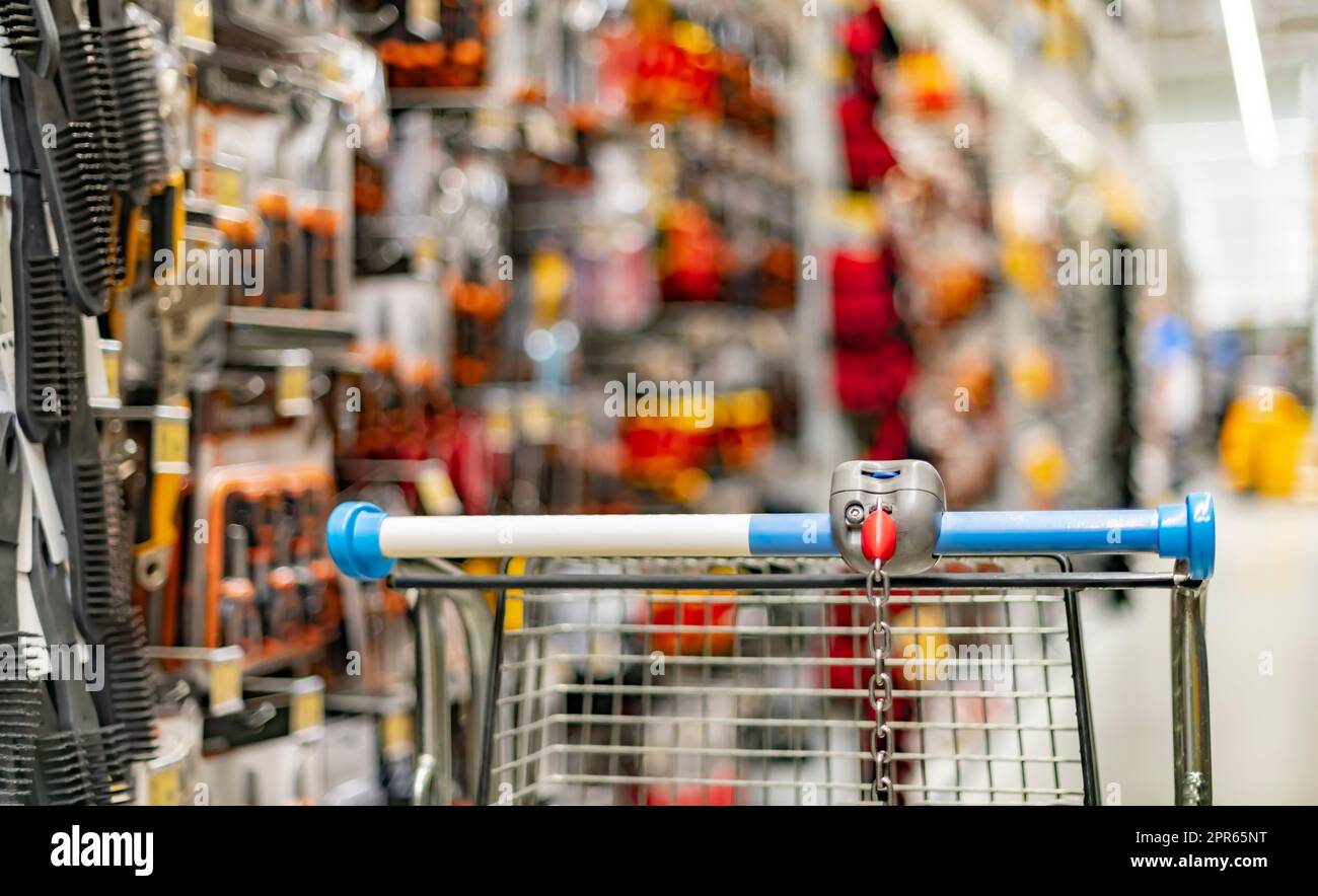 A shopping cart by a store shelf in a hardware store Stock Photo - Alamy