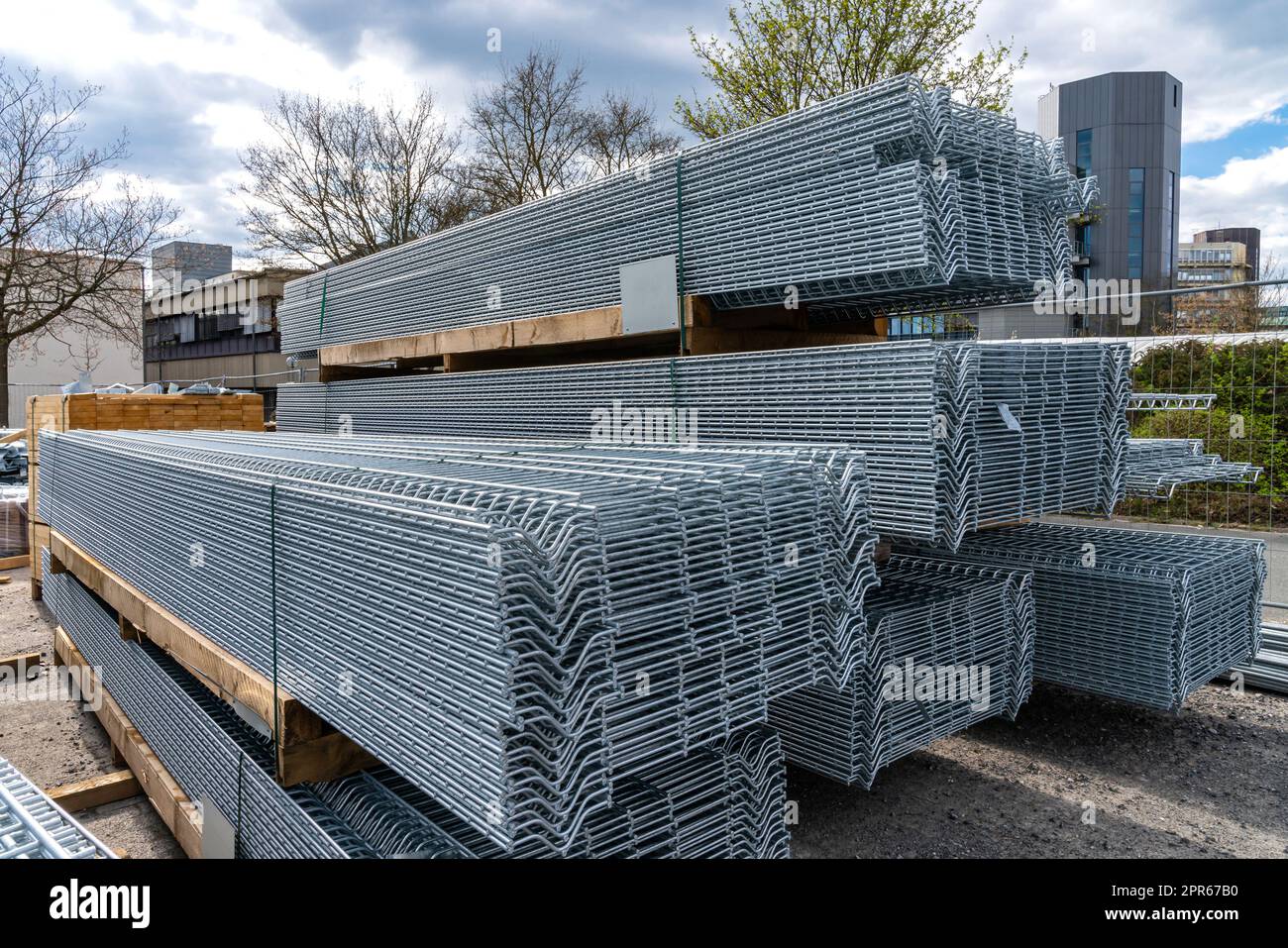 Long grey metal grating stacked in stacks at a construction site Stock ...