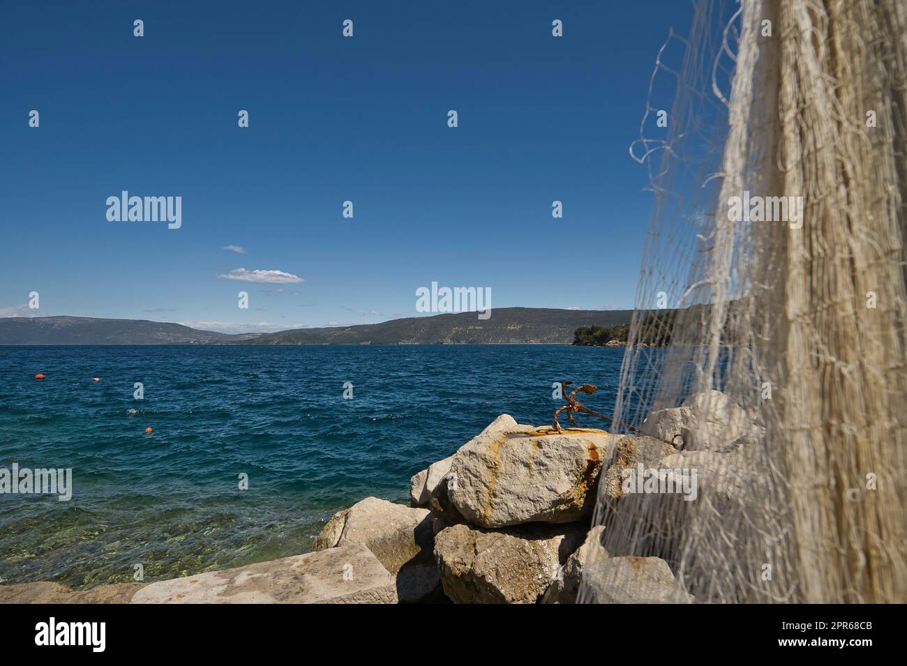 An old anchor and a suspended fishing net Stock Photo - Alamy