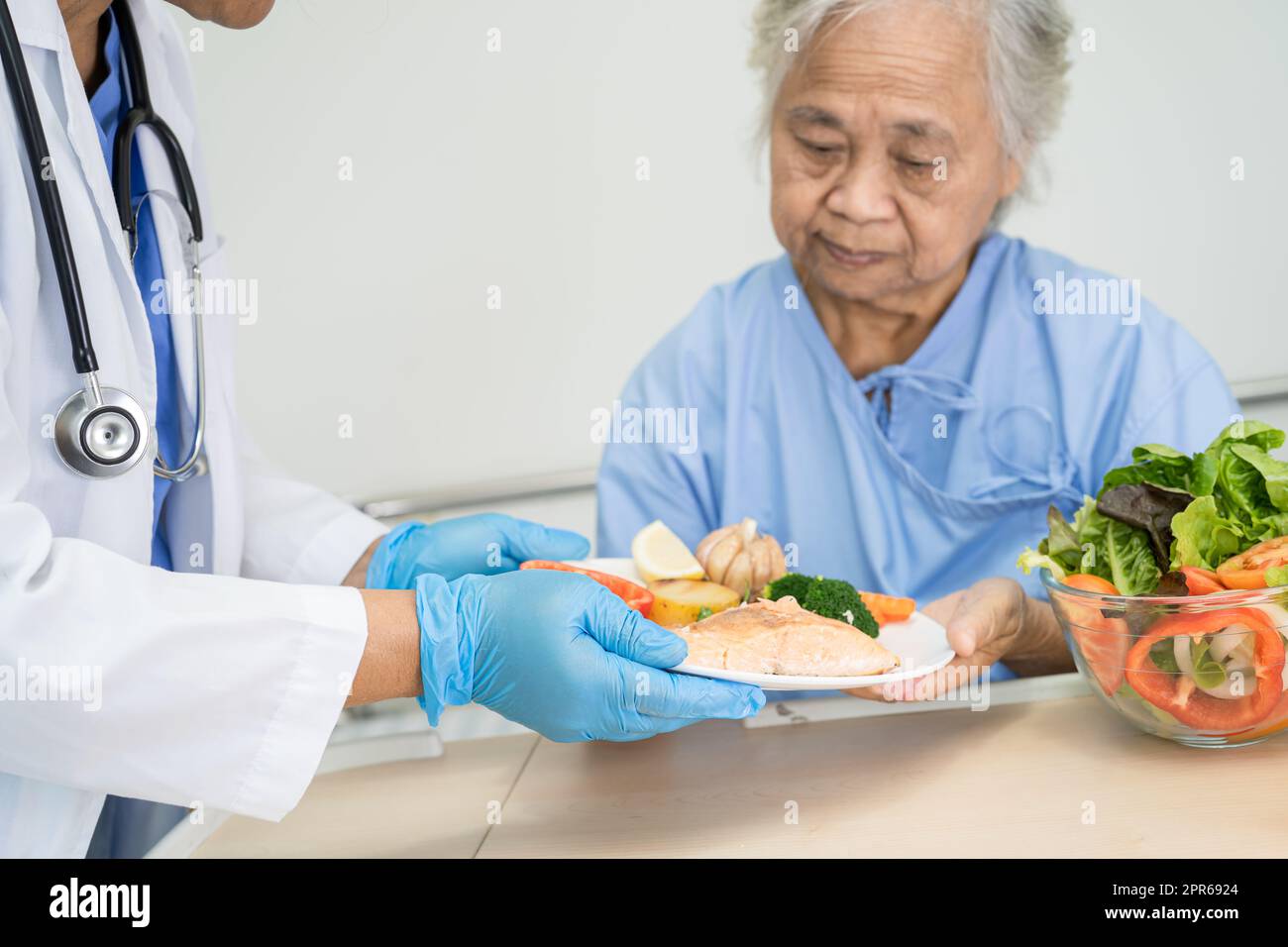 Asian senior or elderly old lady woman patient eating breakfast and ...