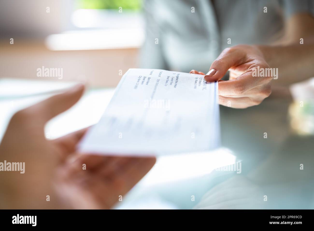 Executive Hand Giving Payment Check Stock Photo - Alamy