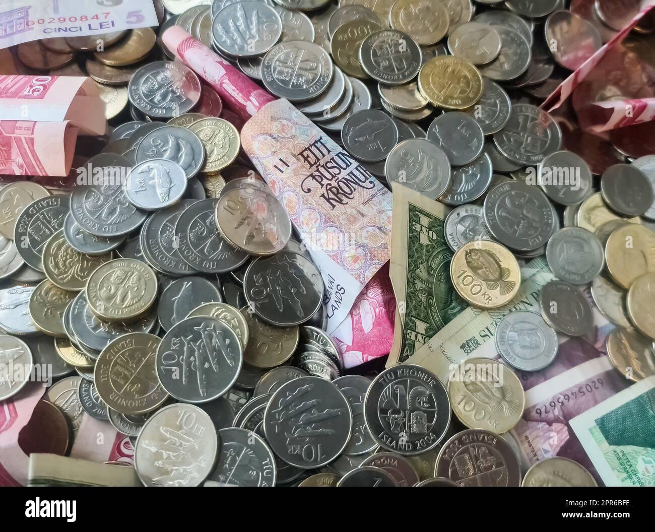 A lot of Icelandic coins and banknotes mixed with other currencies ...
