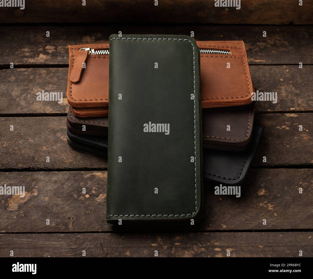 Set of stylish leather wallets on a vintage wooden background. Copy ...