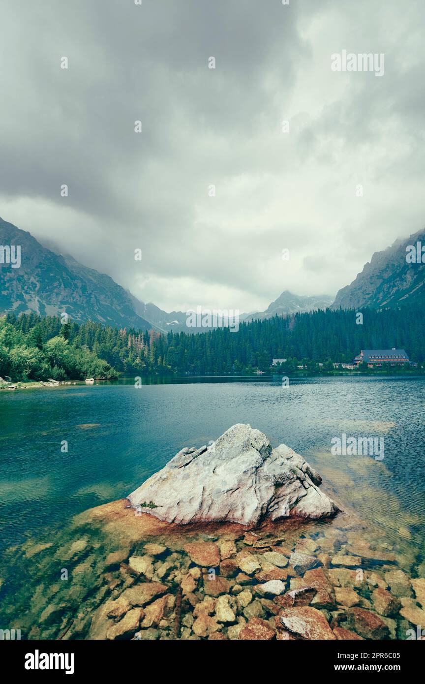 Peaceful mountain lake with big rock in water. Artistic picture Stock ...