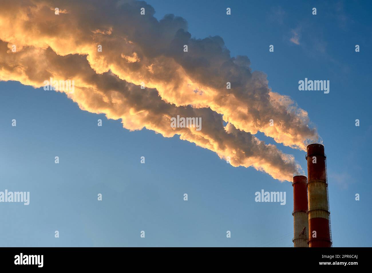 white smoke is coming out of the pipes in the blue sky Stock Photo - Alamy