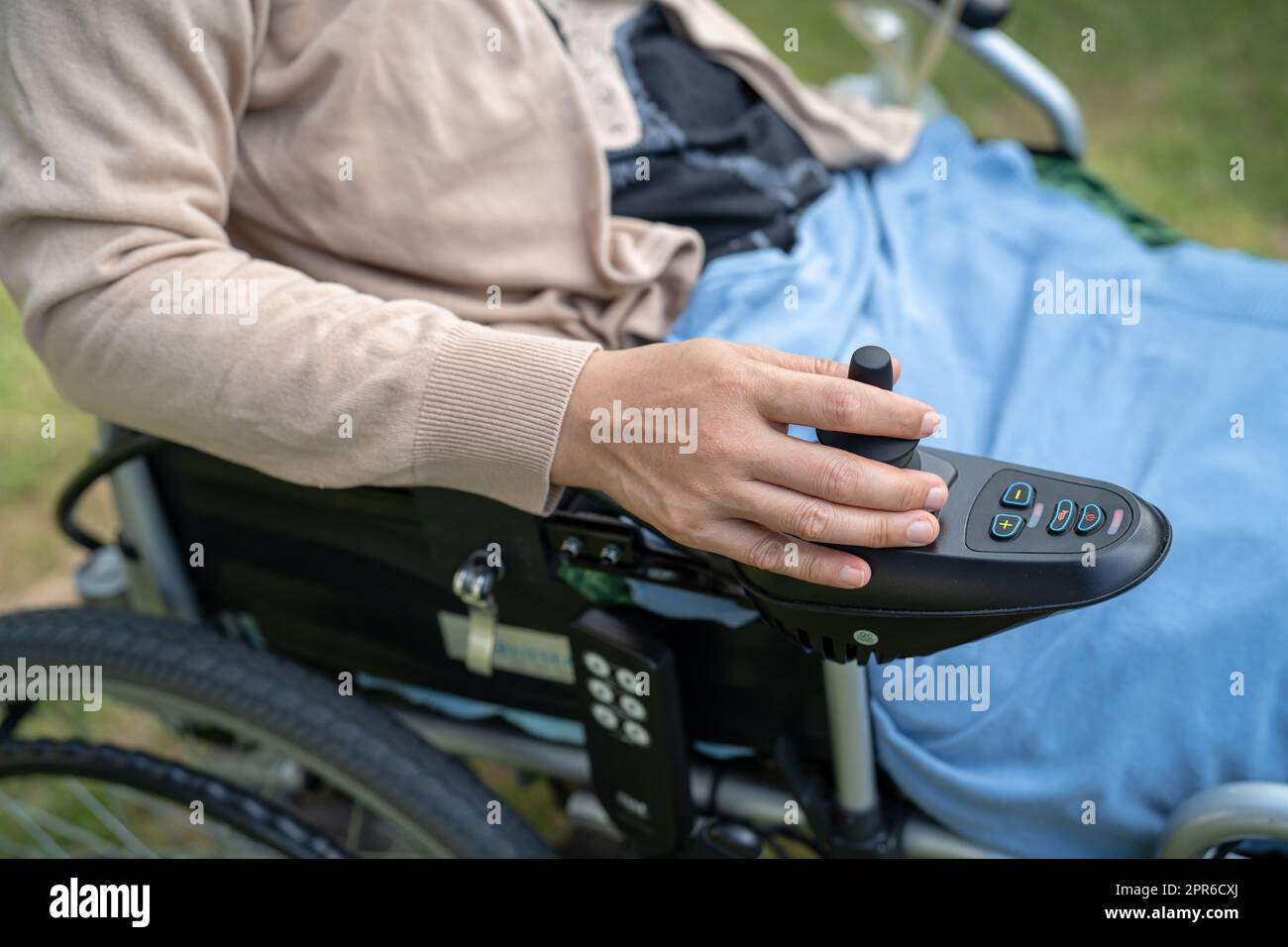 Asian lady woman patient on electric wheelchair with joystick and ...
