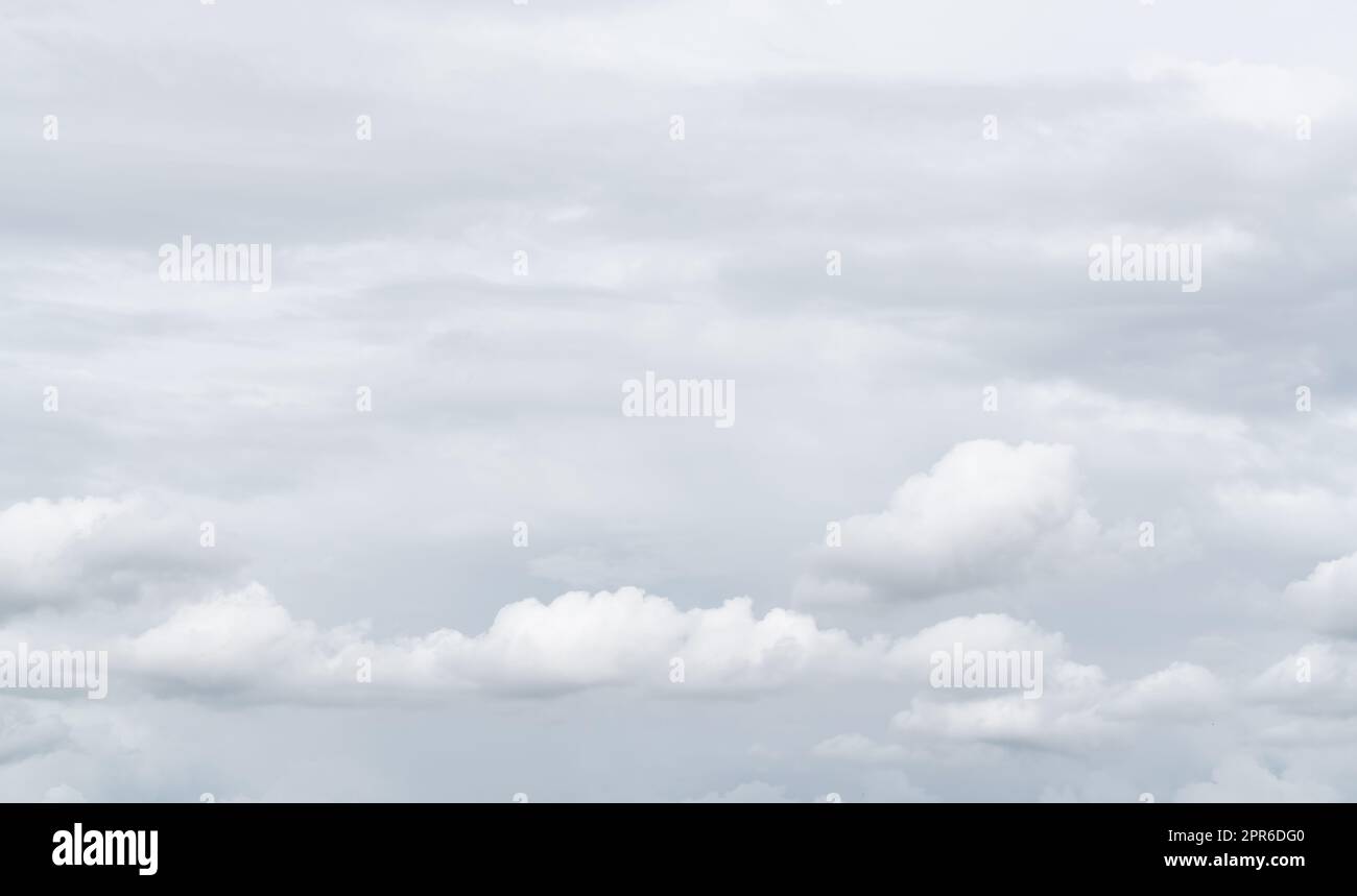 White cumulus clouds on gray sky texture background. Full frame of cloudscape background. Cloudy ...