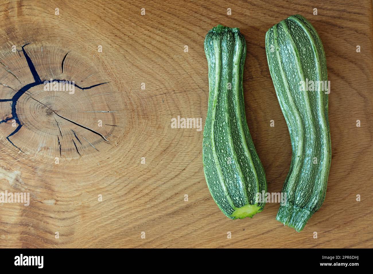Courgette Costata Romanesco on a wooden board Stock Photo - Alamy