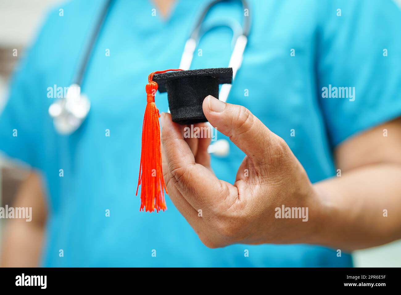 Asian woman doctor holding graduation hat in hospital, Medical ...