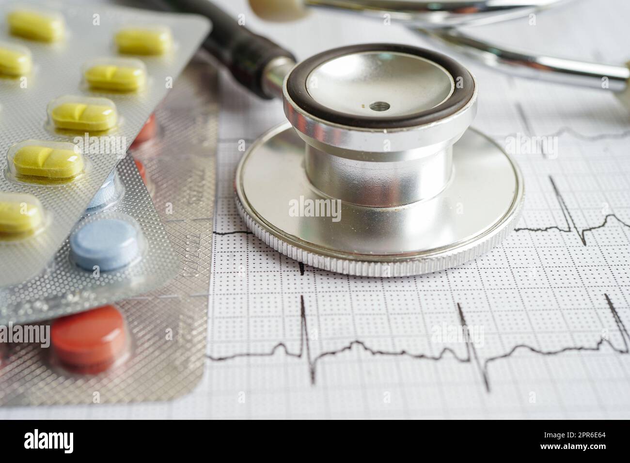 Stethoscope on electrocardiogram (ECG) with drug, heart wave, heart ...