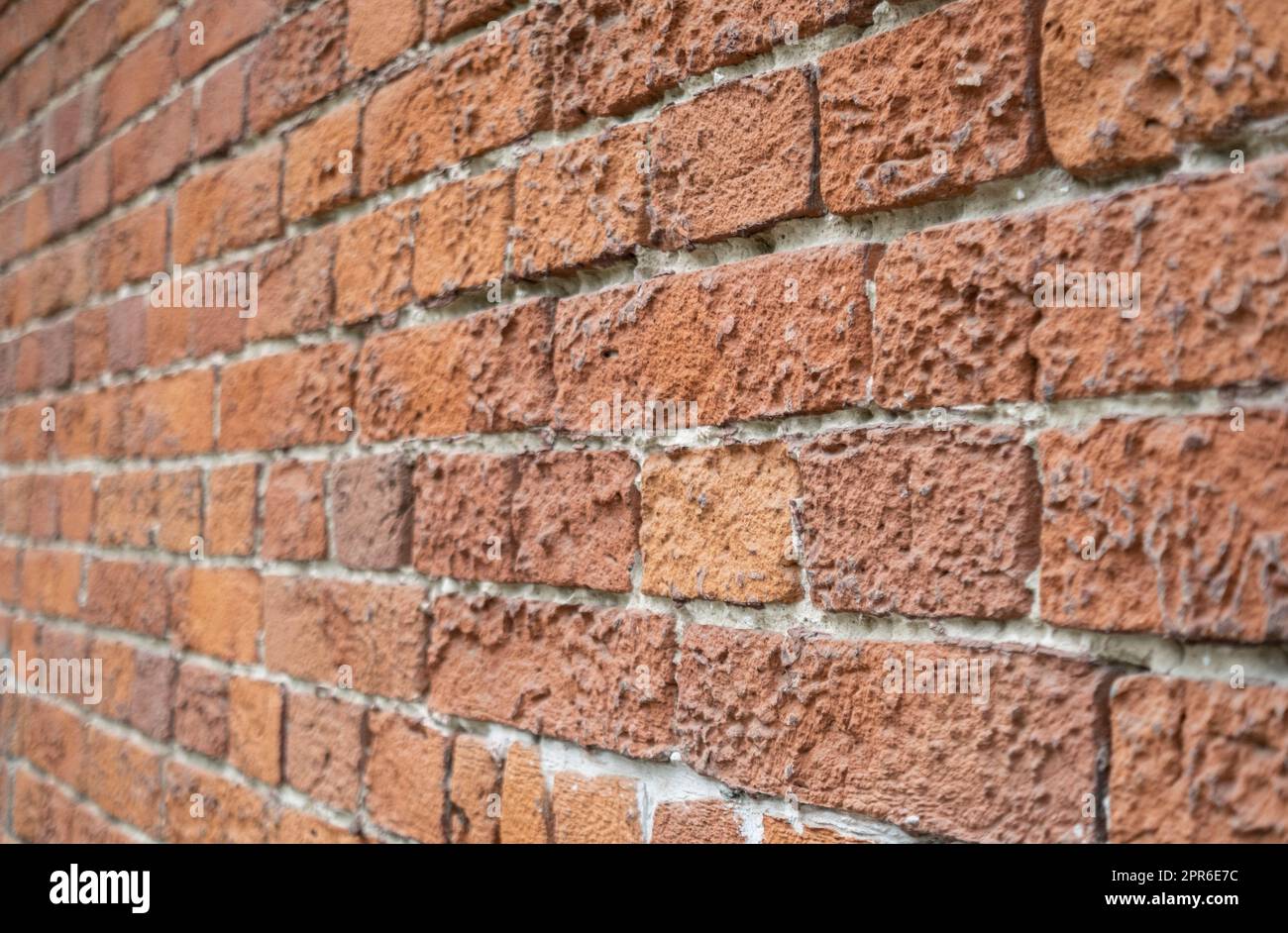 A red brick wall background side view Stock Photo - Alamy