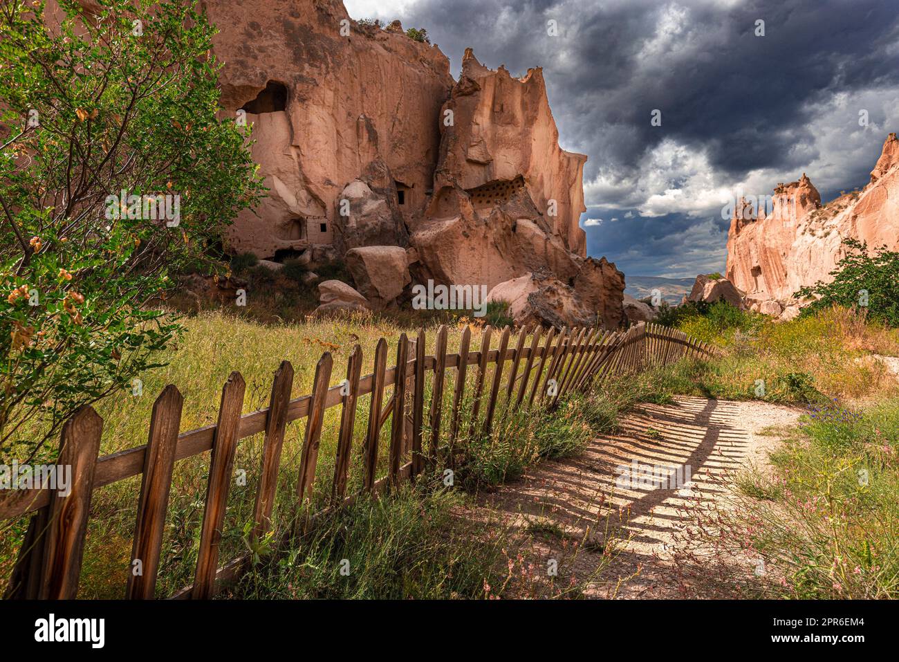 cave and rock formations, wooden fence in the zelve valley cappadocia ...