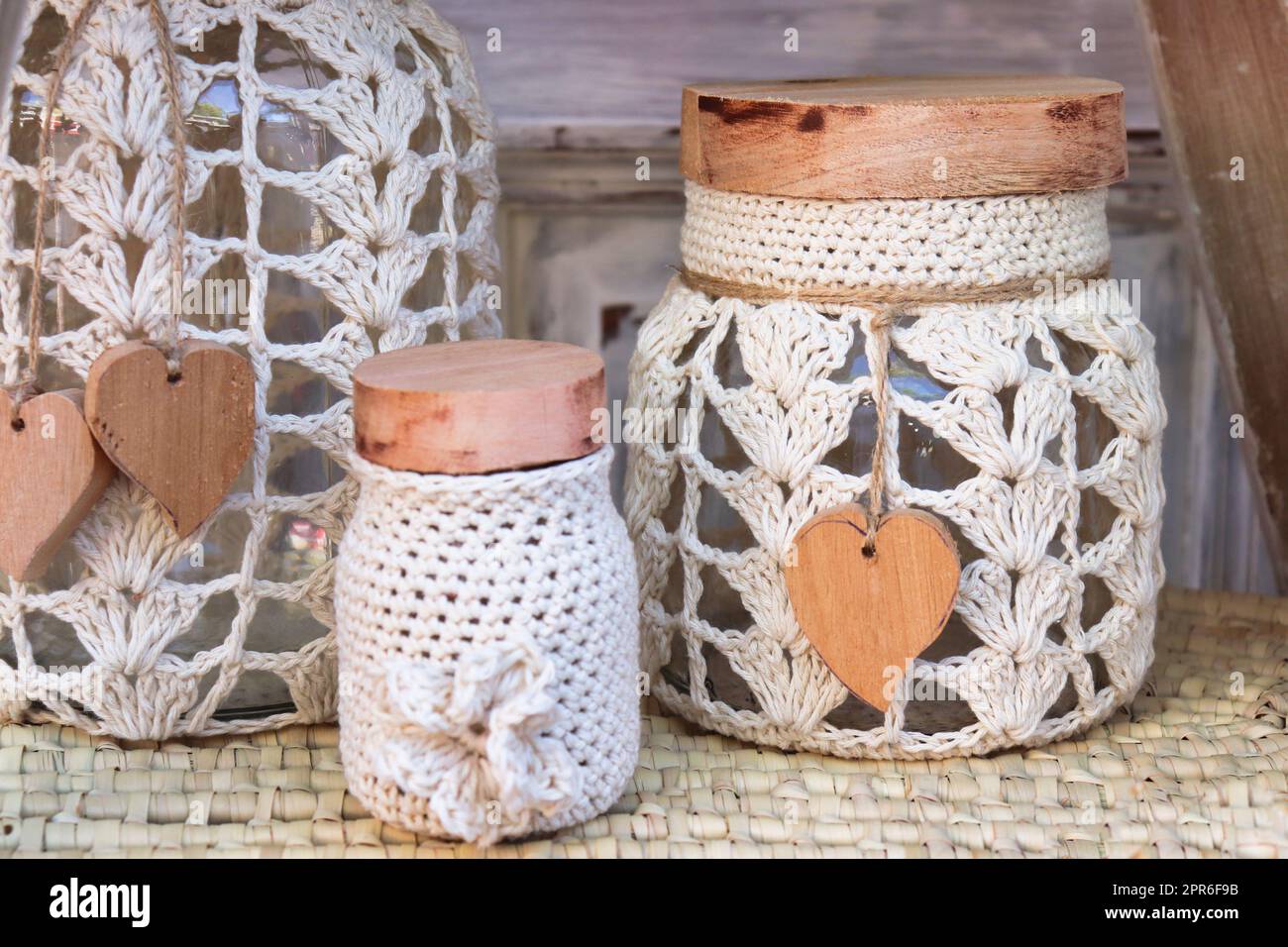 glass jars covered in handmade crochet fabric Stock Photo - Alamy