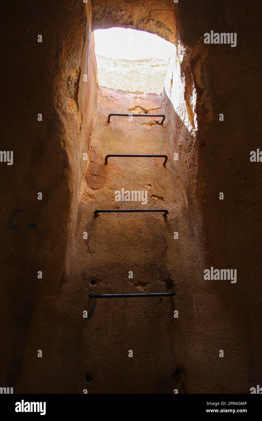 Metallic ladder inside the Albercutx watchtower, an ancient round stone ...