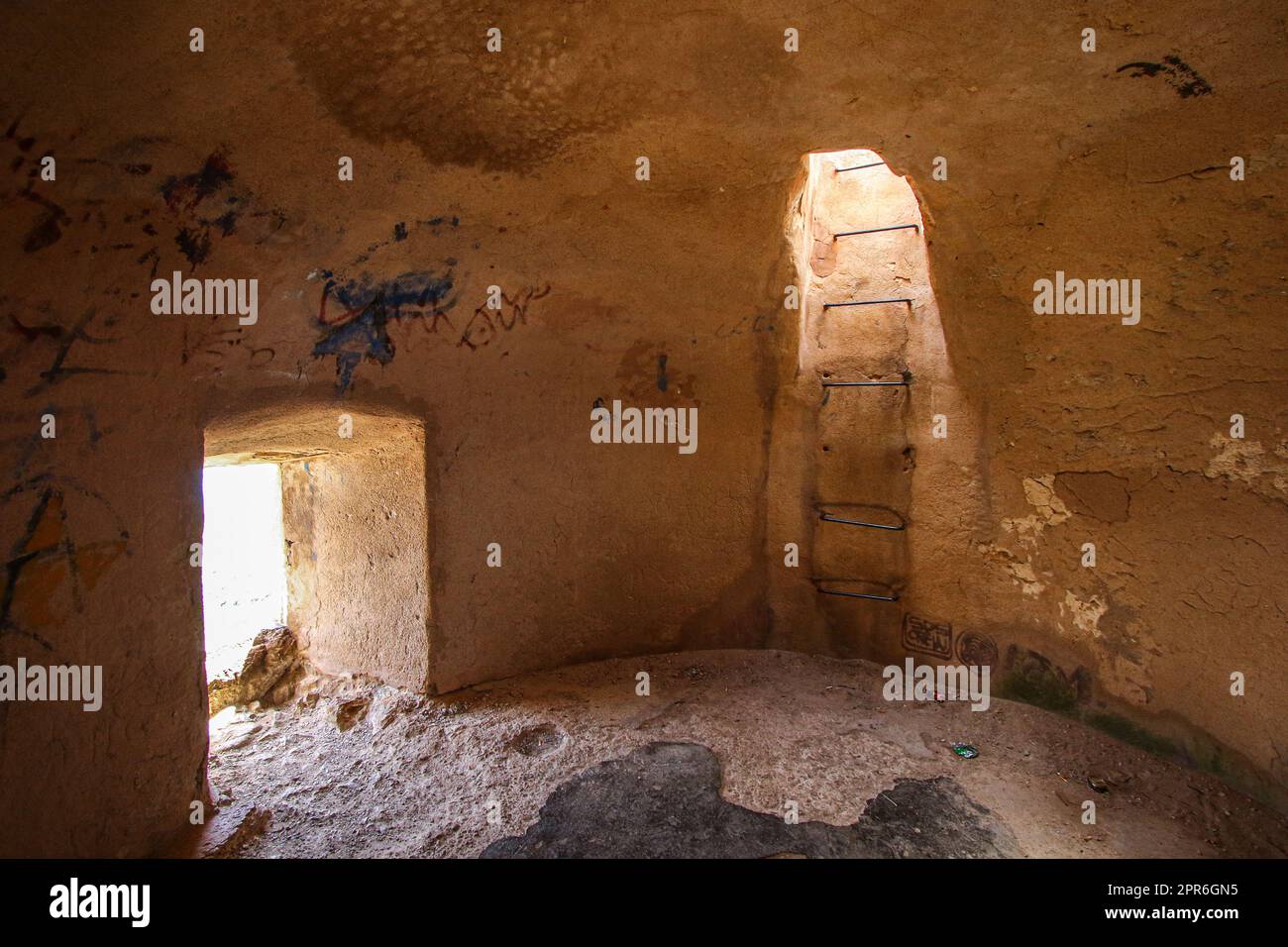 Metallic ladder inside the Albercutx watchtower, an ancient round stone ...