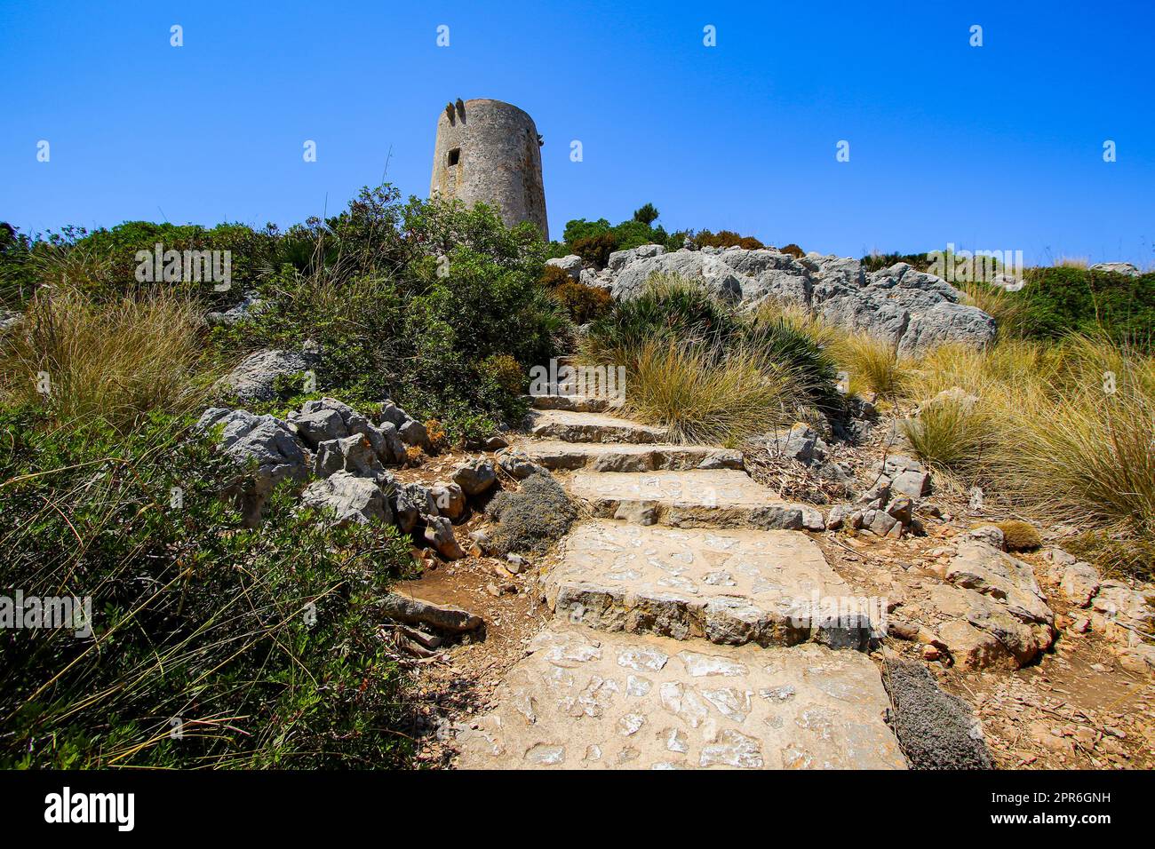 Albercutx watchtower is an ancient round stone fort built at the top of ...