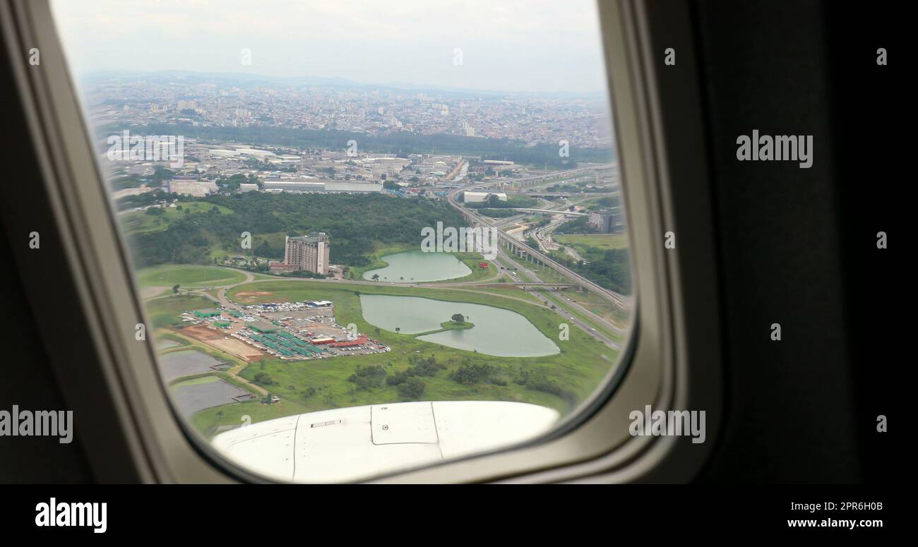 Passenger airplane window taking off. POV overlooking plane seat window ...