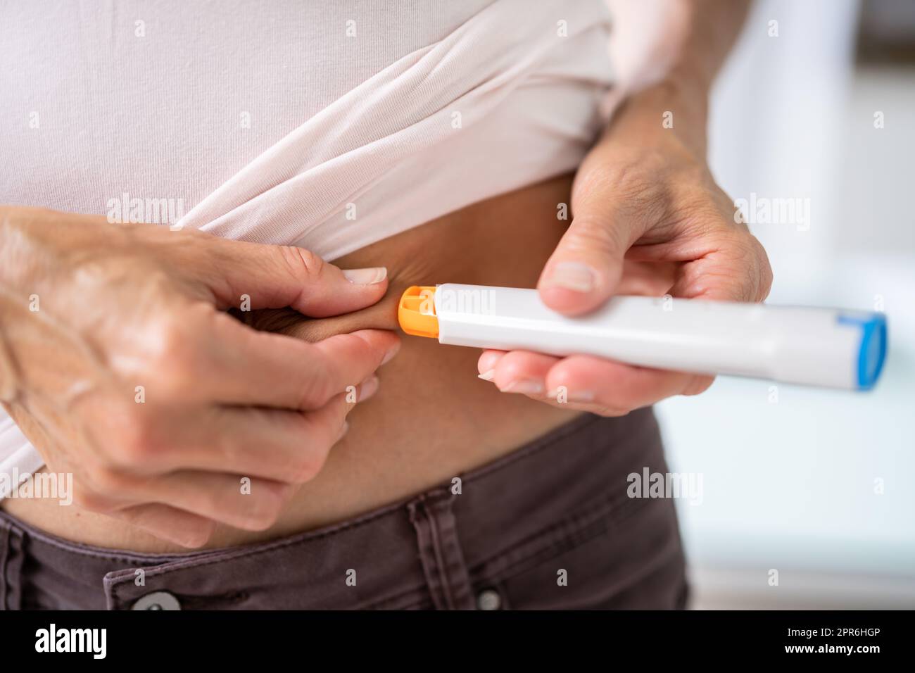 Medicament Self Injection In Belly Using Syringe Stock Photo - Alamy
