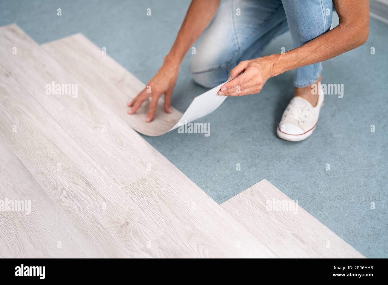 Installing New Vinyl Laminate. Woman Fixing Floor Stock Photo - Alamy