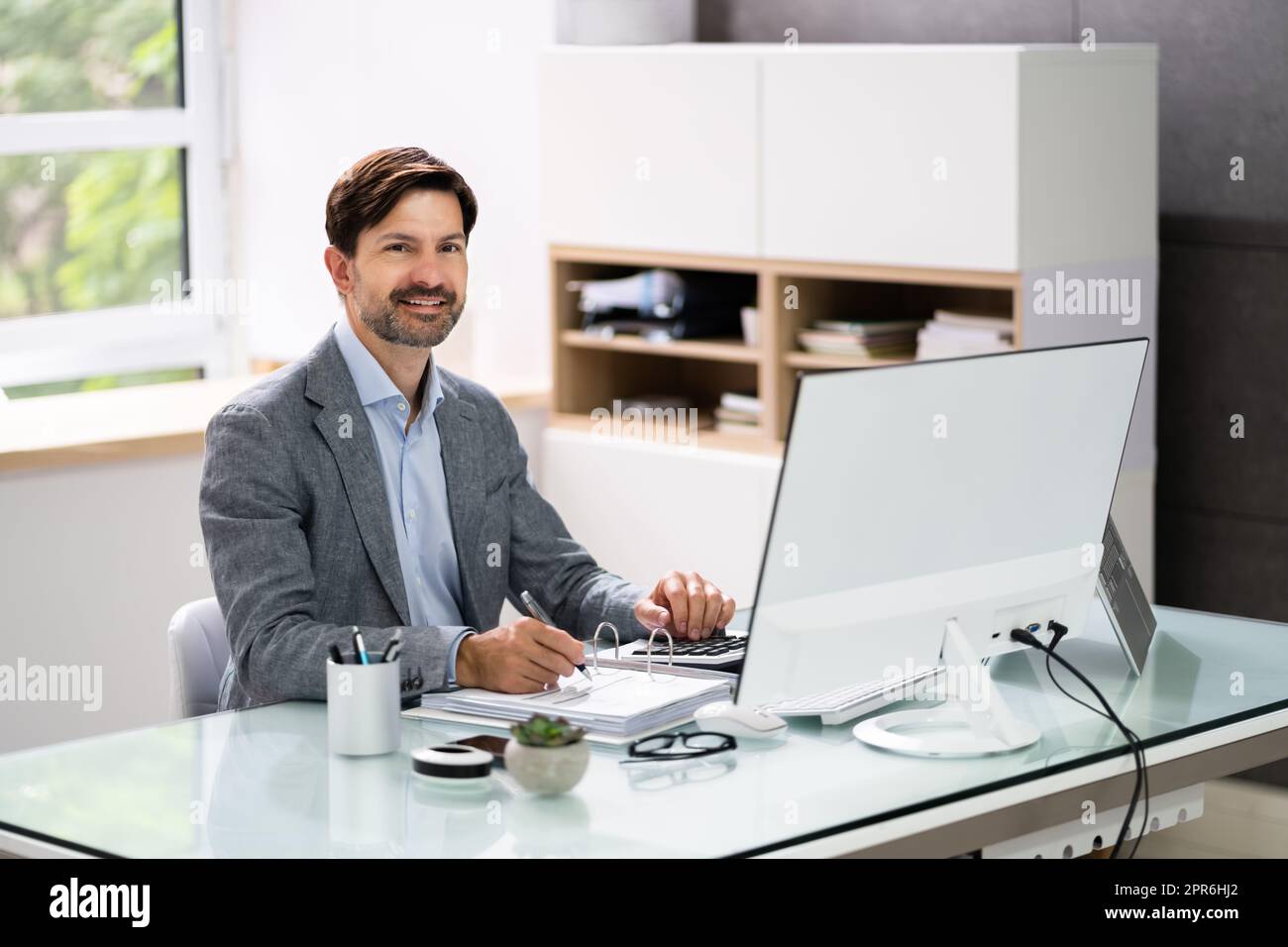 Accountant calculating finance calculator hi-res stock photography and ...