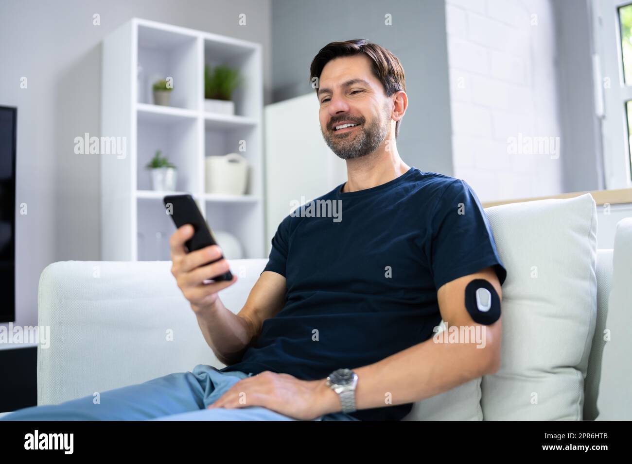 Man Using Continuous Glucose Remote Monitor Diabetes Stock Photo - Alamy