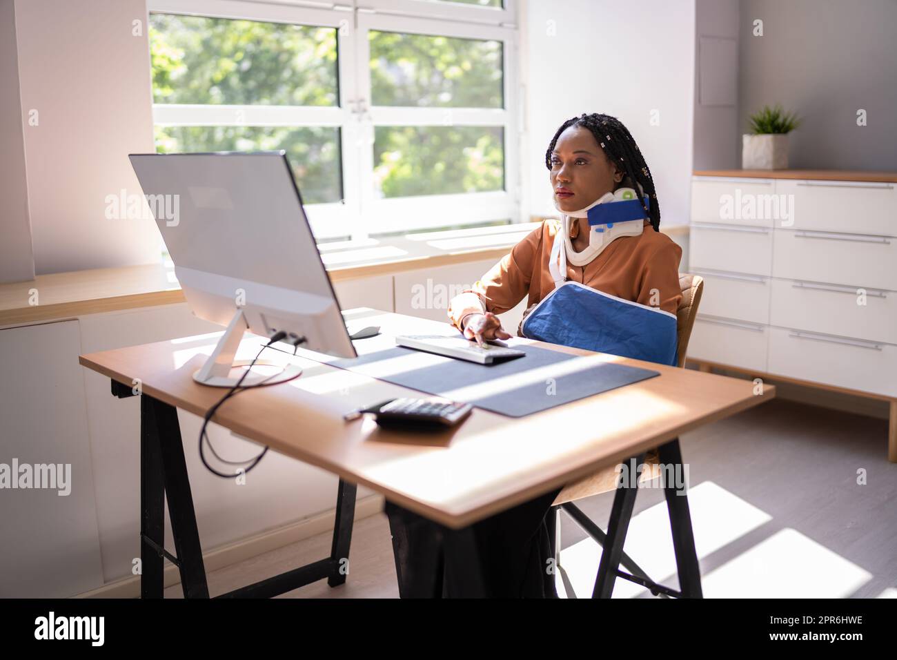Disabled Businesswoman On Wheelchair Using Computer Stock Photo - Alamy
