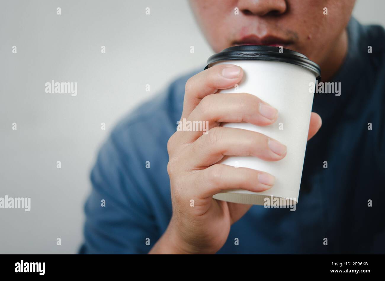 Close up man holding coffee to take away Stock Photo - Alamy