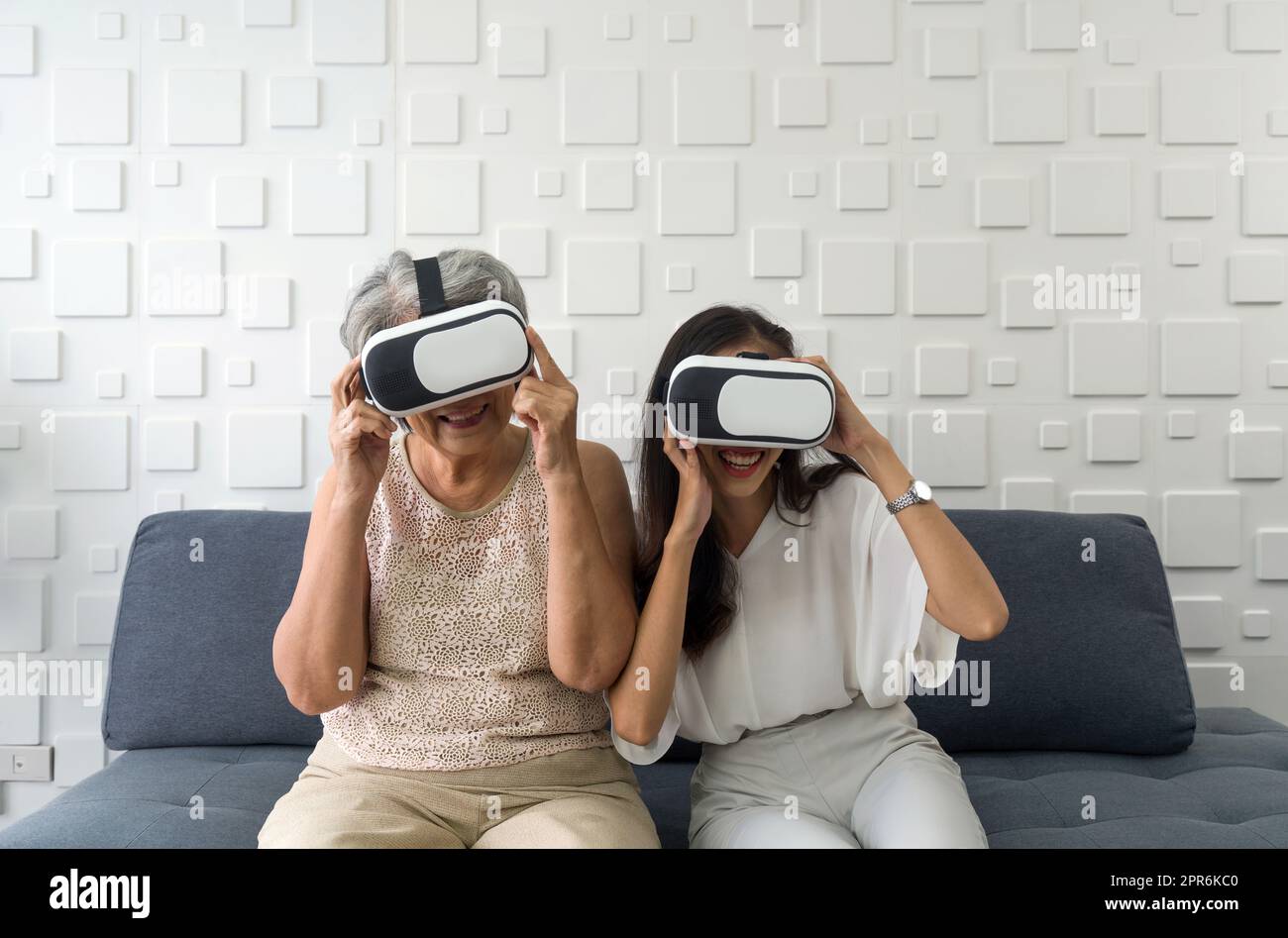 Happy family living together, asian woman and her grandmother play an ...