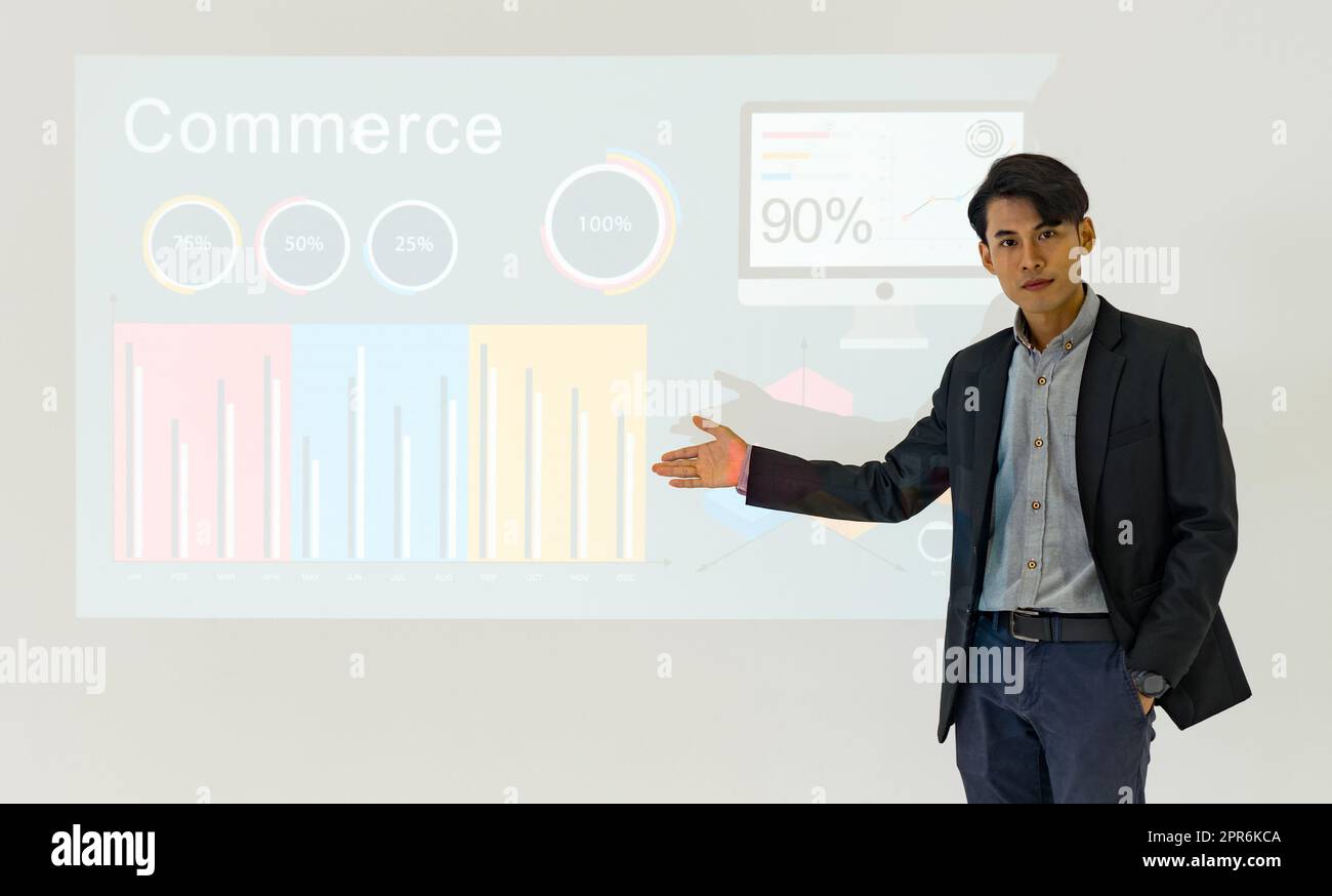 Young asian businessman in suit giving presentation with projector ...