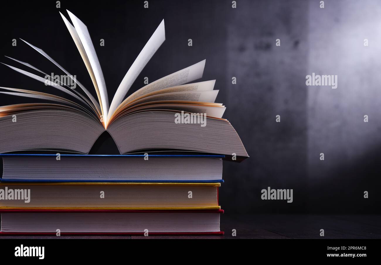 Composition with open book on the table Stock Photo - Alamy