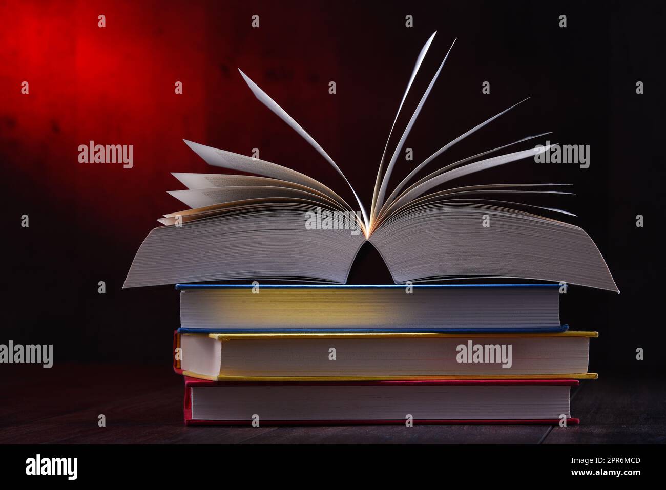 Composition with open book on the table Stock Photo - Alamy
