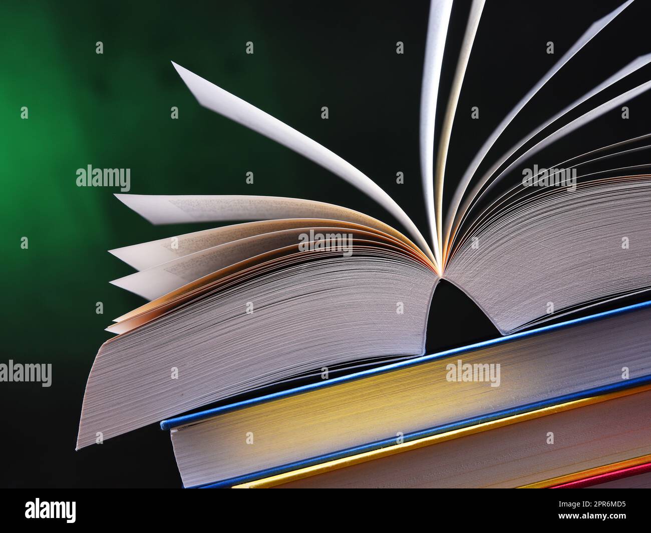 Composition with open book on the table Stock Photo - Alamy