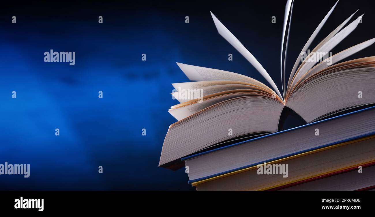 Composition with open book on the table Stock Photo - Alamy