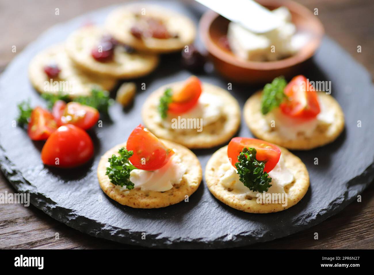 Appetizers and snacks, crackers, dried fruit, tomatoes, parsley, and ...