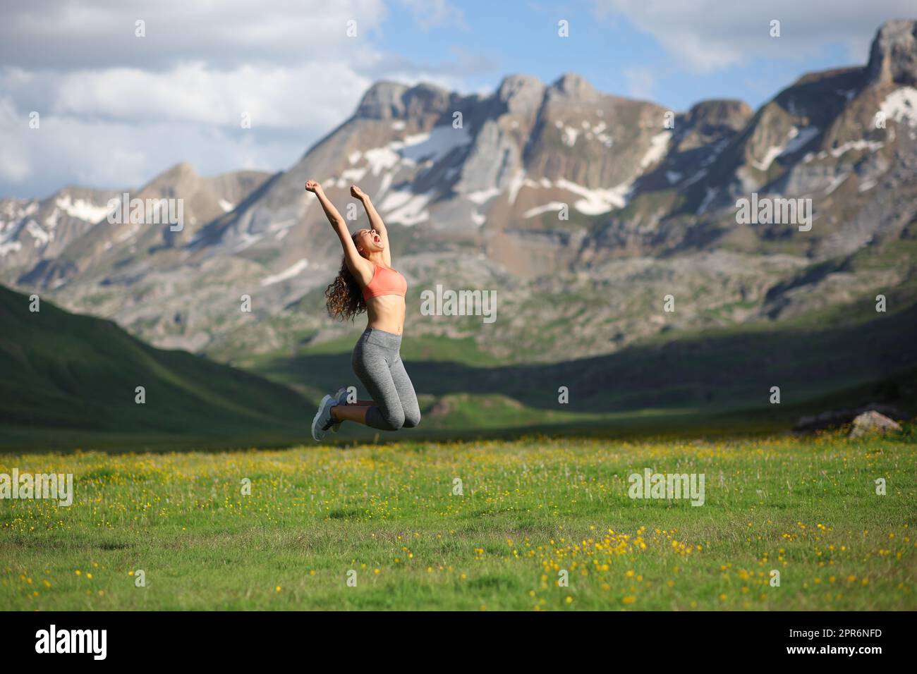 Runner jumping in a high mountain Stock Photo - Alamy