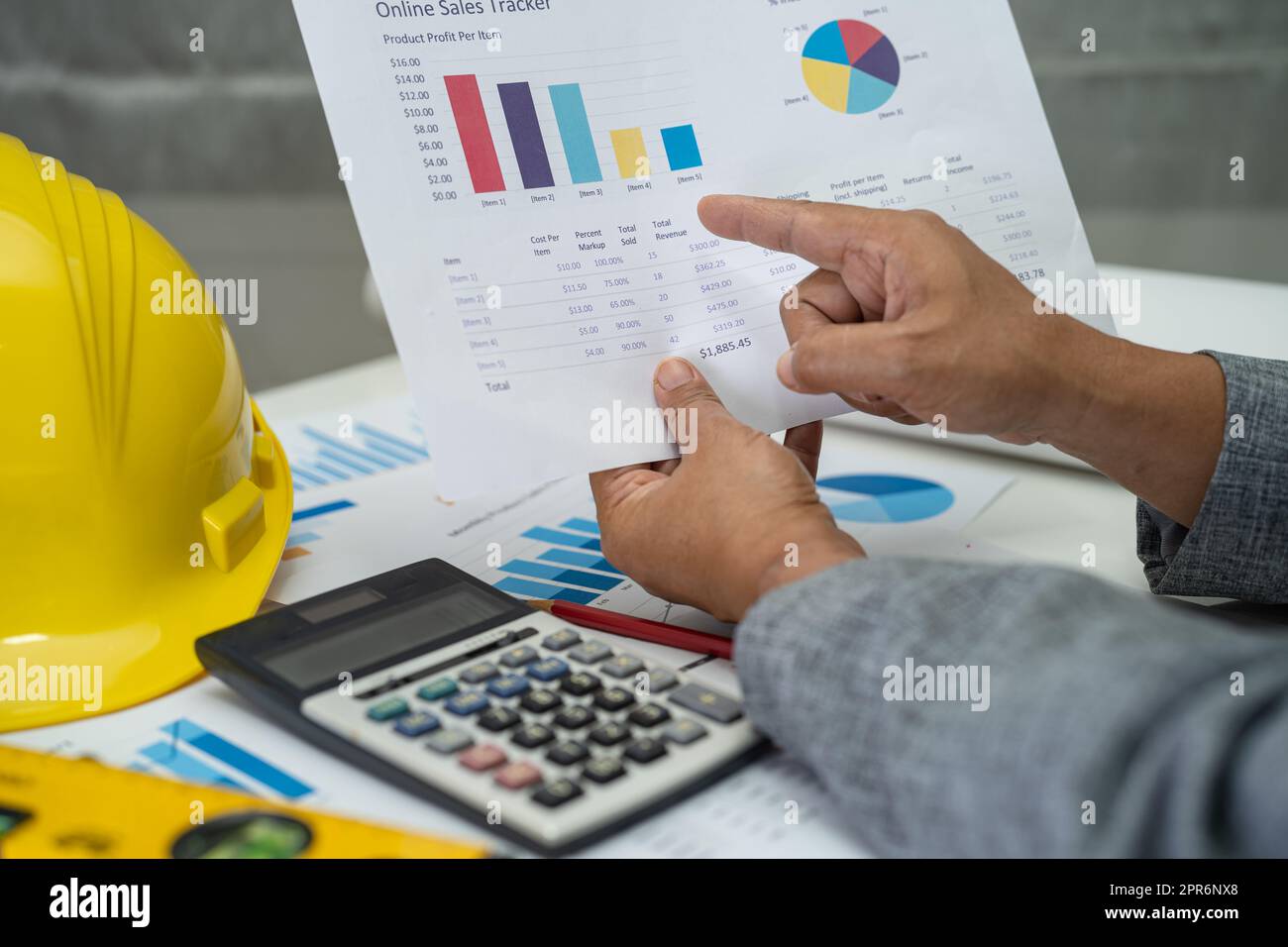 Asian engineer with architectural house plan project blueprint, graph ...