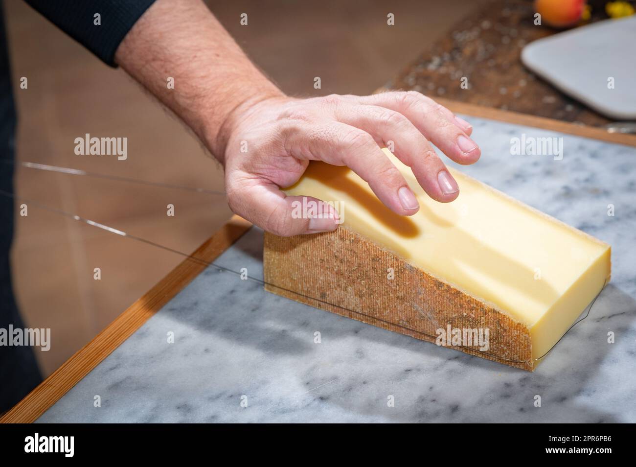 Famous and tasted part of cheese ha sbeen cuted with a wire Stock Photo ...