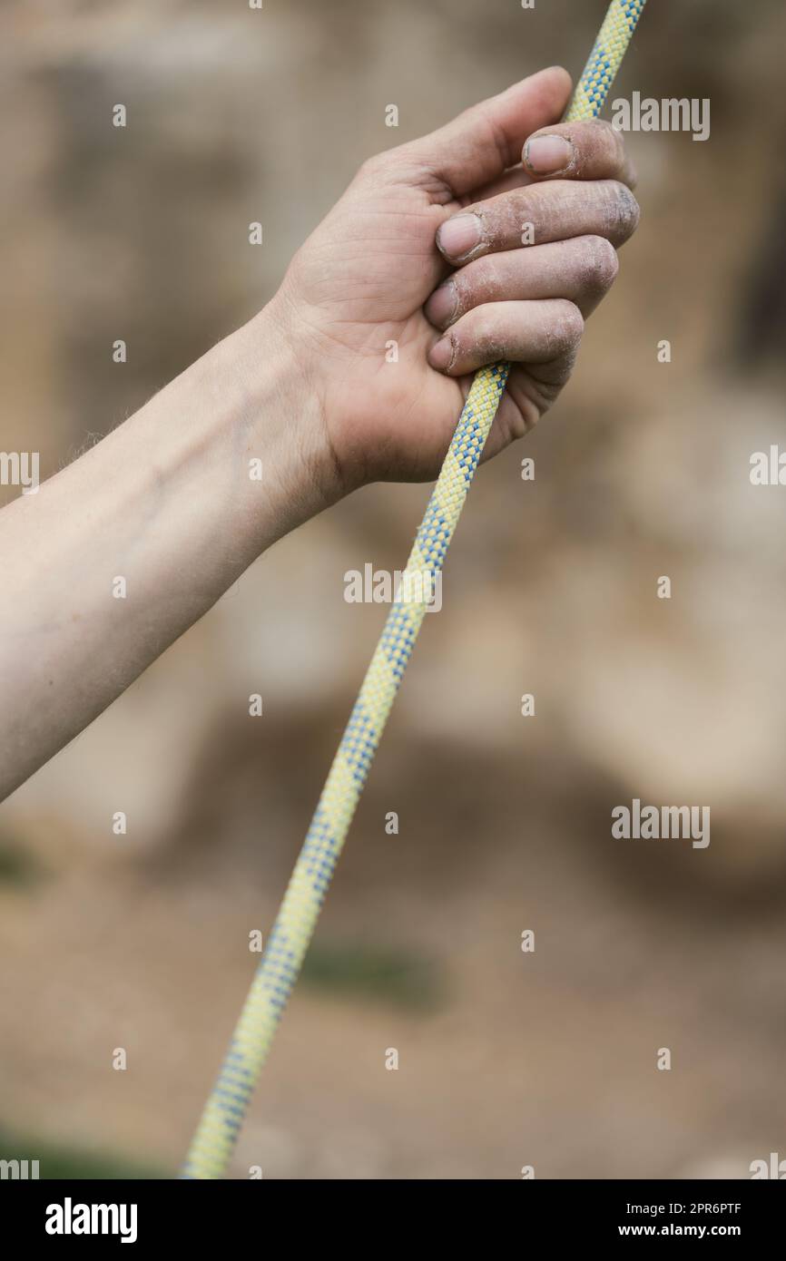 Hand holding a rock climbing rope Stock Photo - Alamy