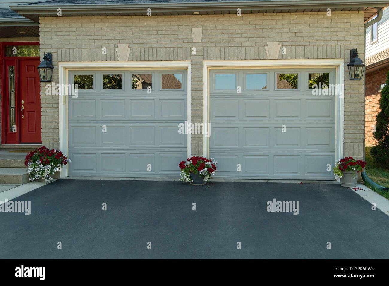 Two separate garages in one house Stock Photo - Alamy