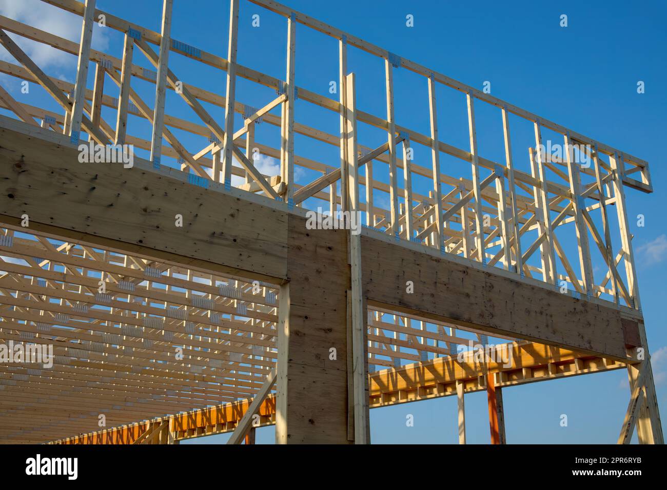 house under construction wood frame structure roof beams planks ...