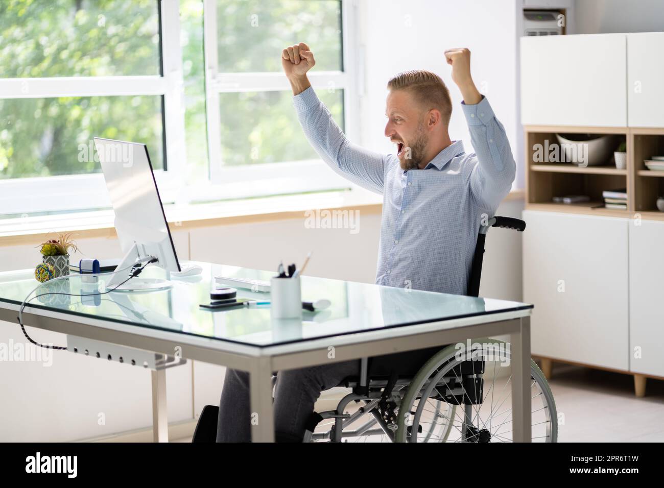 Disable Young Worker Using Computer. Physical Therapy Stock Photo - Alamy
