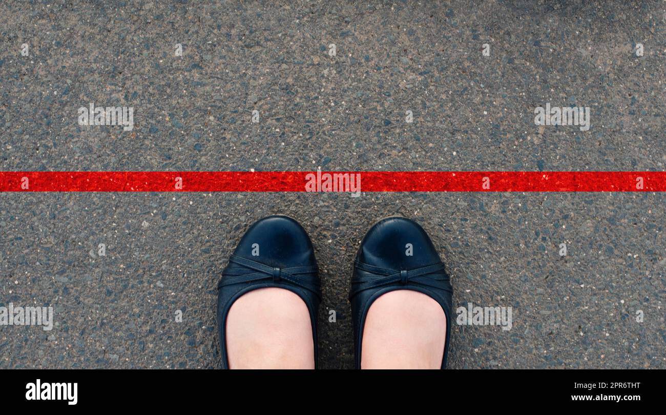 Red line on the road, someone is standing in front of the stop, having ...
