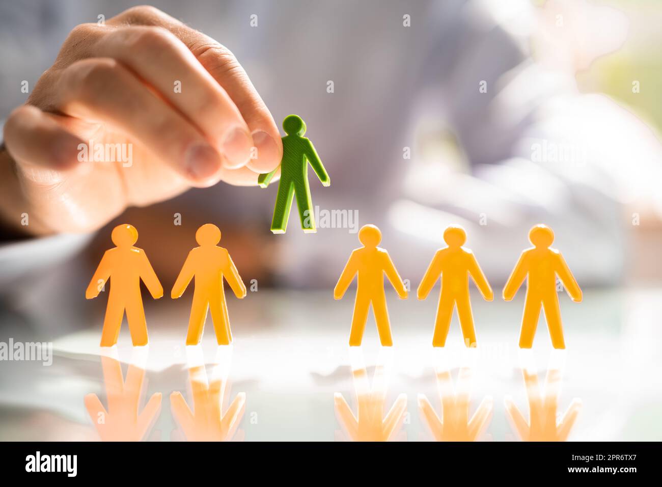 Businessperson Picking Red Human Figures Stock Photo - Alamy