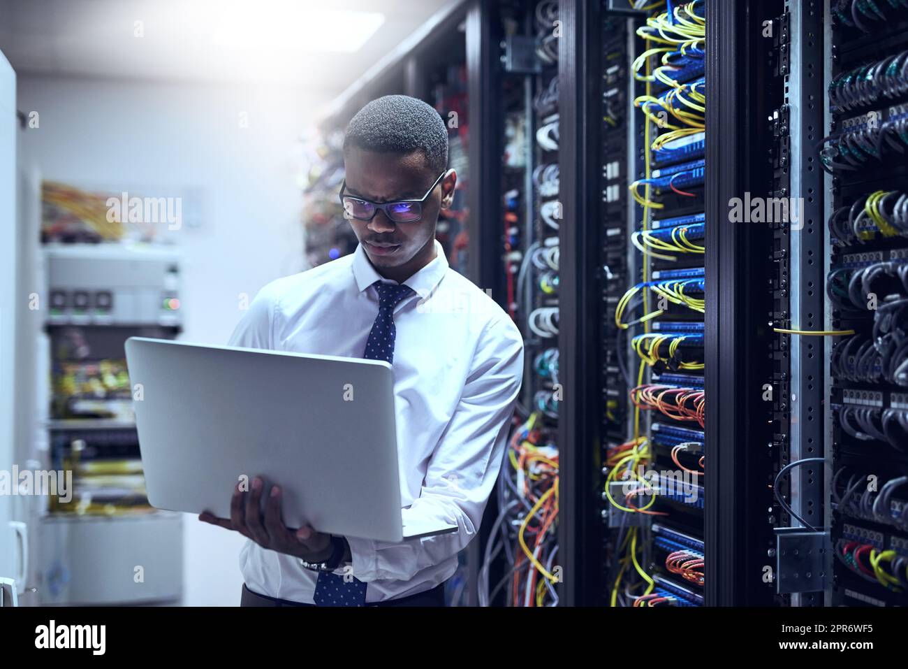 The man with the plan. Cropped shot of a IT technician working on his ...
