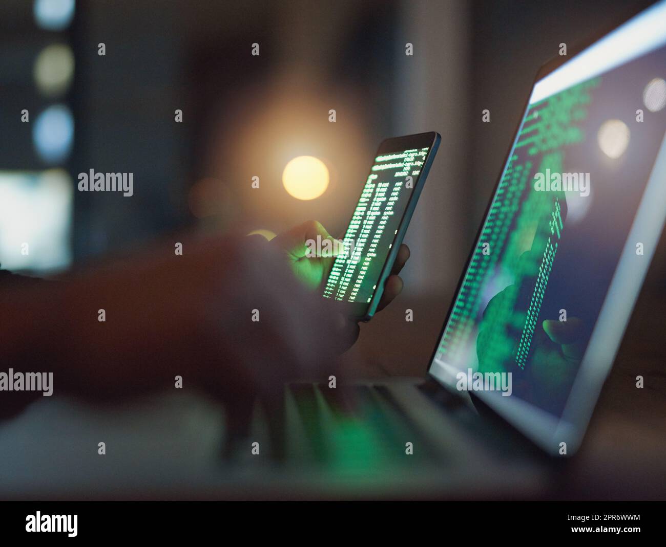 Who knows what a hacker can do with your information. Shot of an unrecognisable hacker using a ...