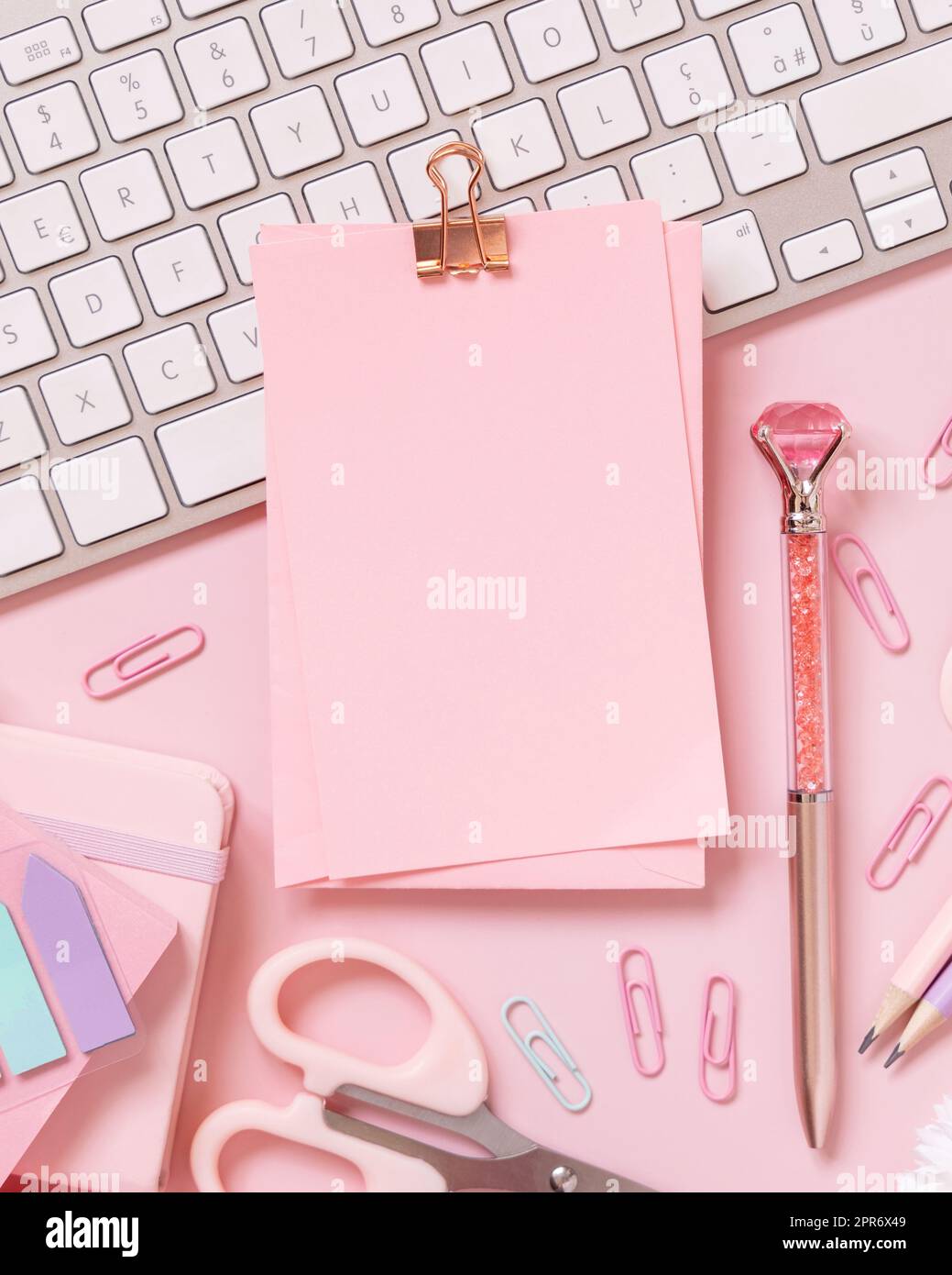 Paper with a clip, Pink school girly accessories and keyboard on pastel ...