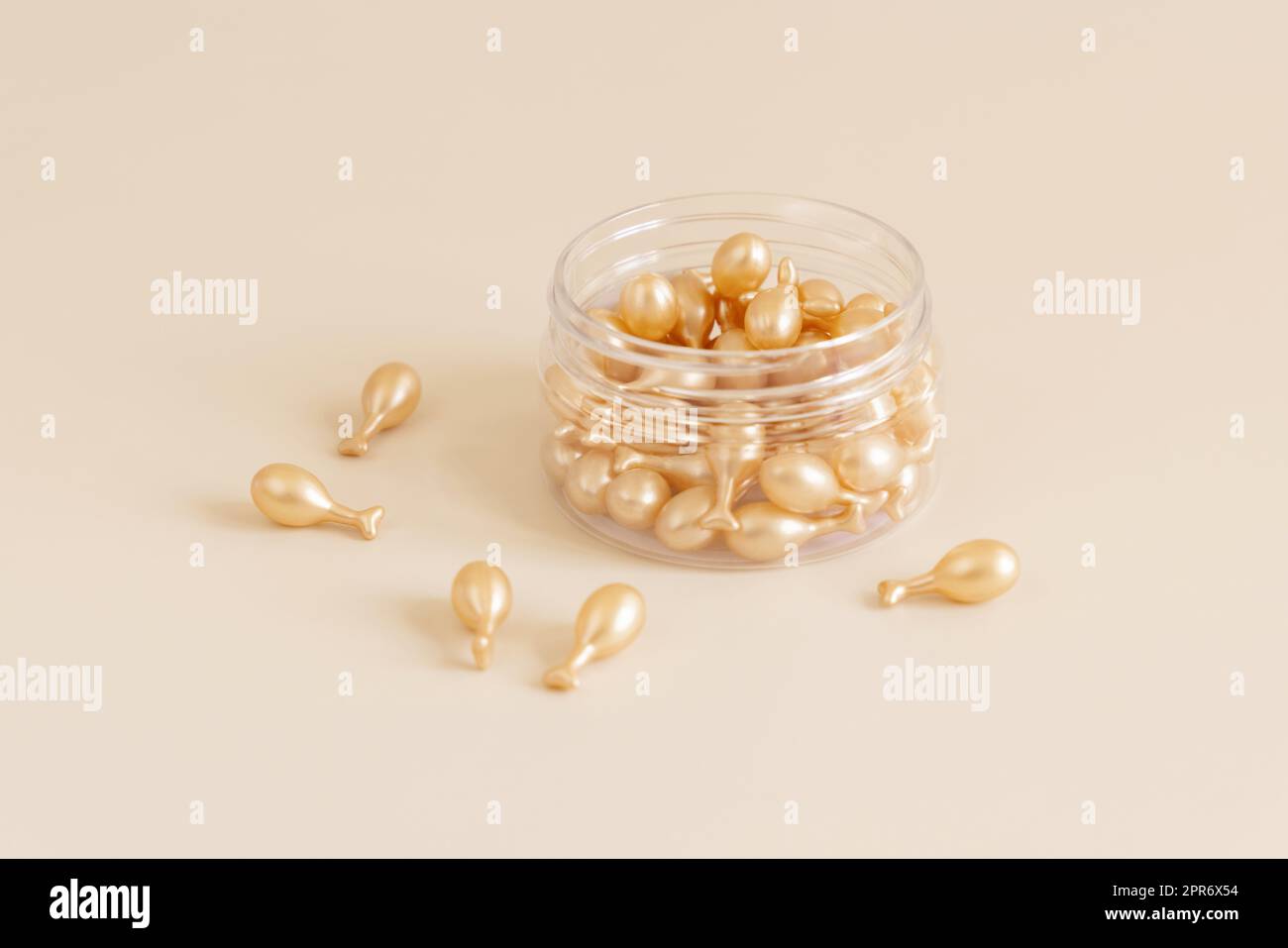 Face serum capsules in a jar on light yellow close up. Cosmetics ...