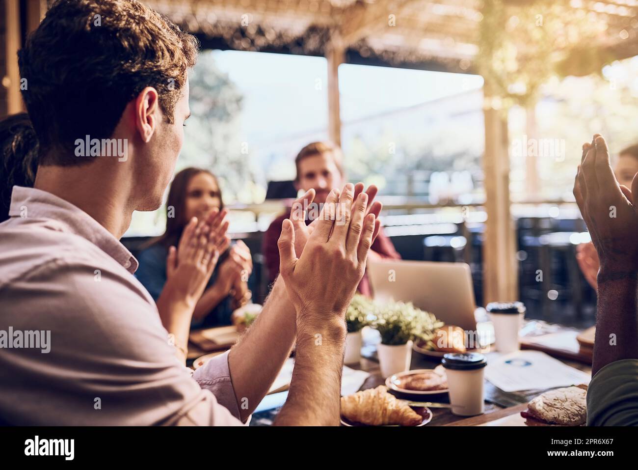Free lunch and good news. Shot of a group of colleagues clapping hands ...