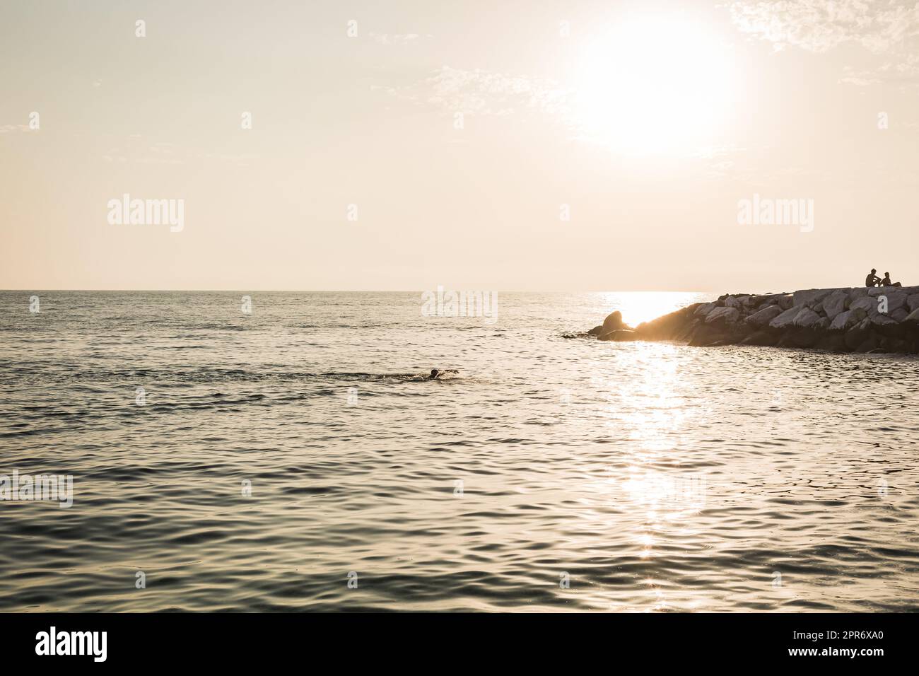 Colorful ocean beach sunrise with deep blue sky and sun rays Stock ...